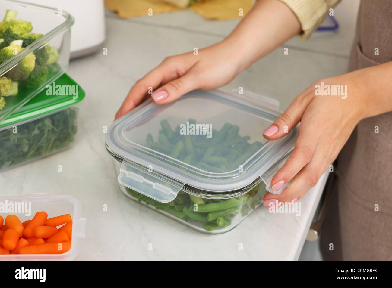 Woman sealing food container hi-res stock photography and images - Alamy