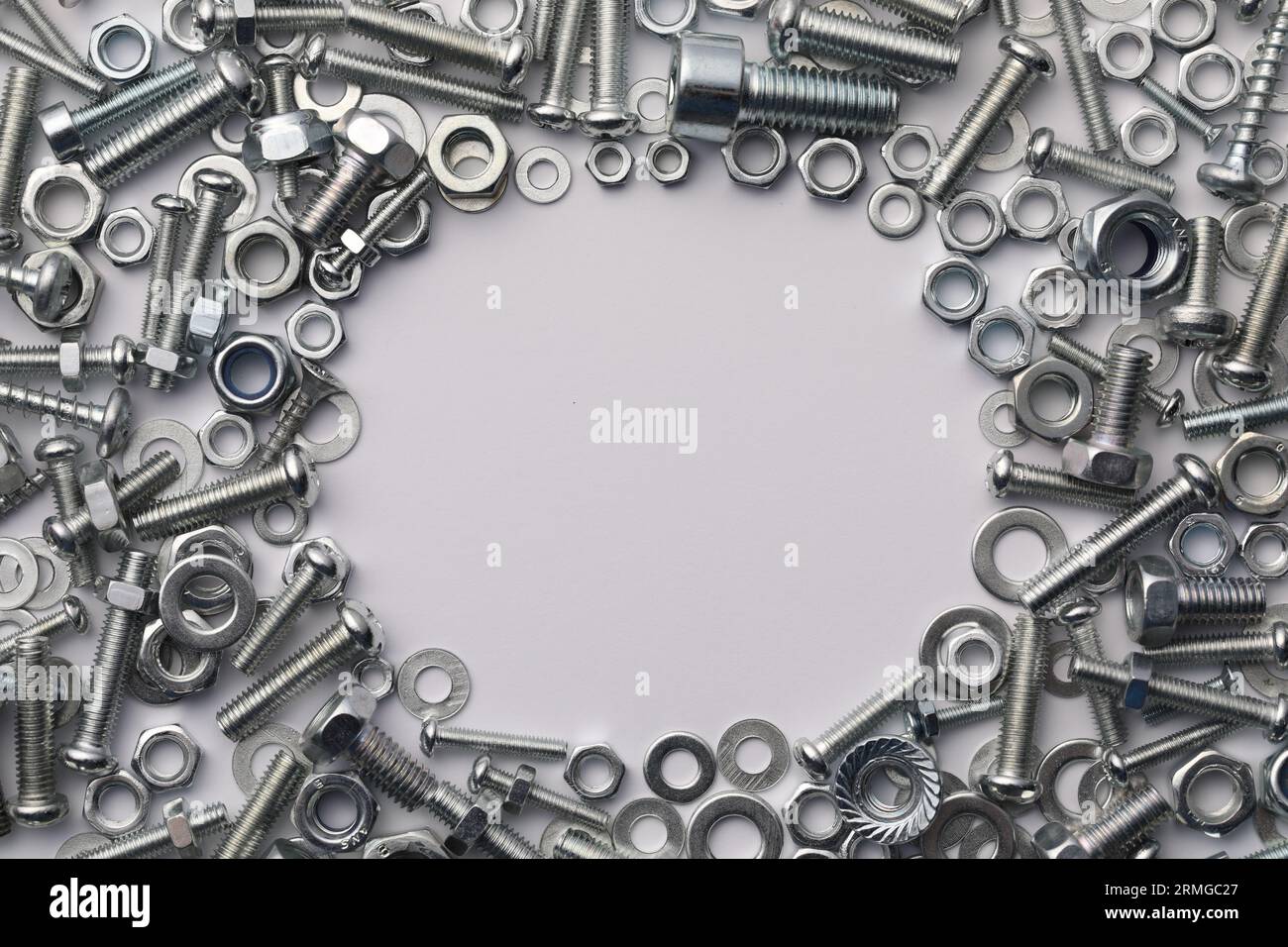 Frame of different metal bolts and nuts on white background, flat lay ...