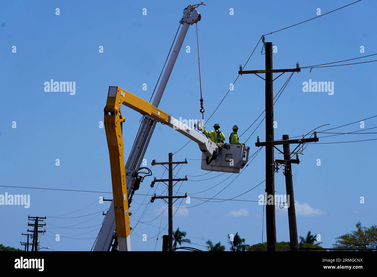 FILE - Linemen work on poles, Aug. 13, 2023, in Lahaina, Hawaii ...