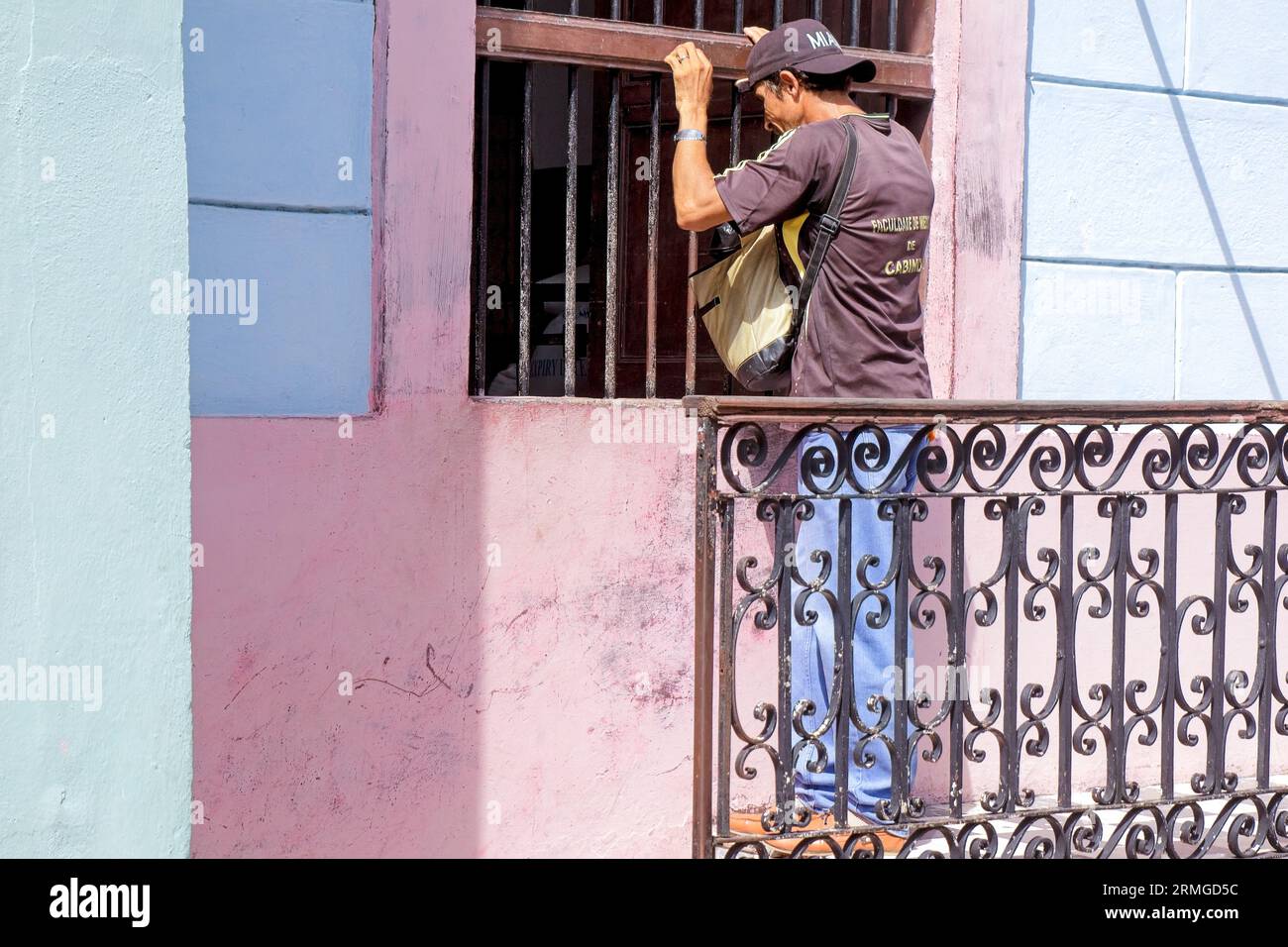 Havana, Cuba, 2023, Man talking through a house window Stock Photo - Alamy