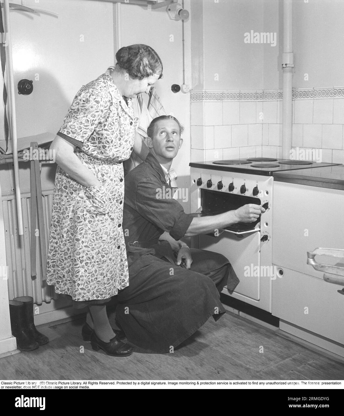 Woman looking installed white kitchen hi-res stock photography and ...