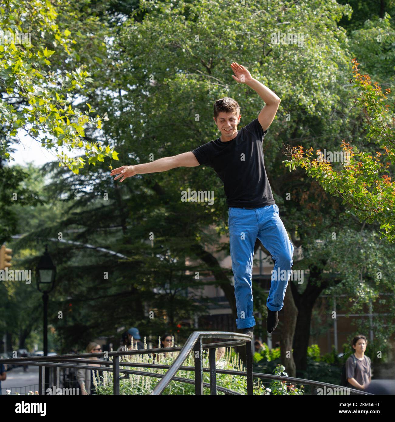 New York, USA - July 21st, 2023: A young man performing acrobatics on a ...