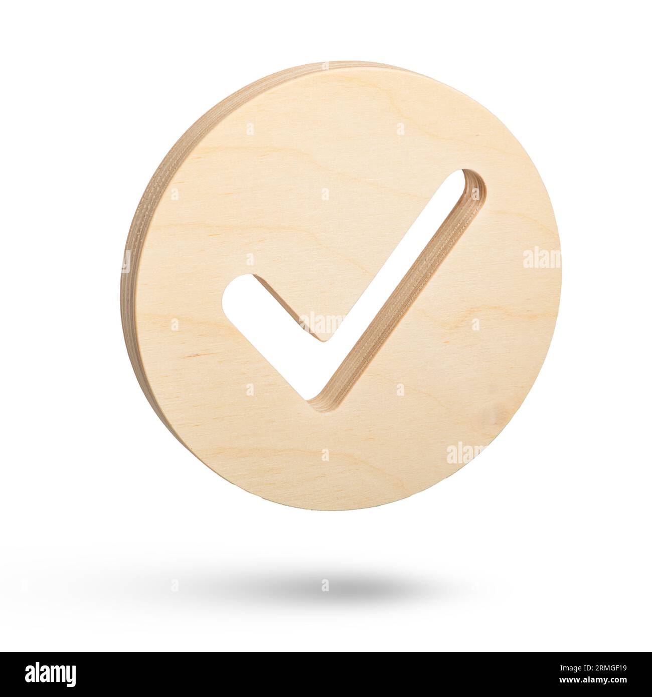 Check mark symbol on white isolated background. A large wooden round ...