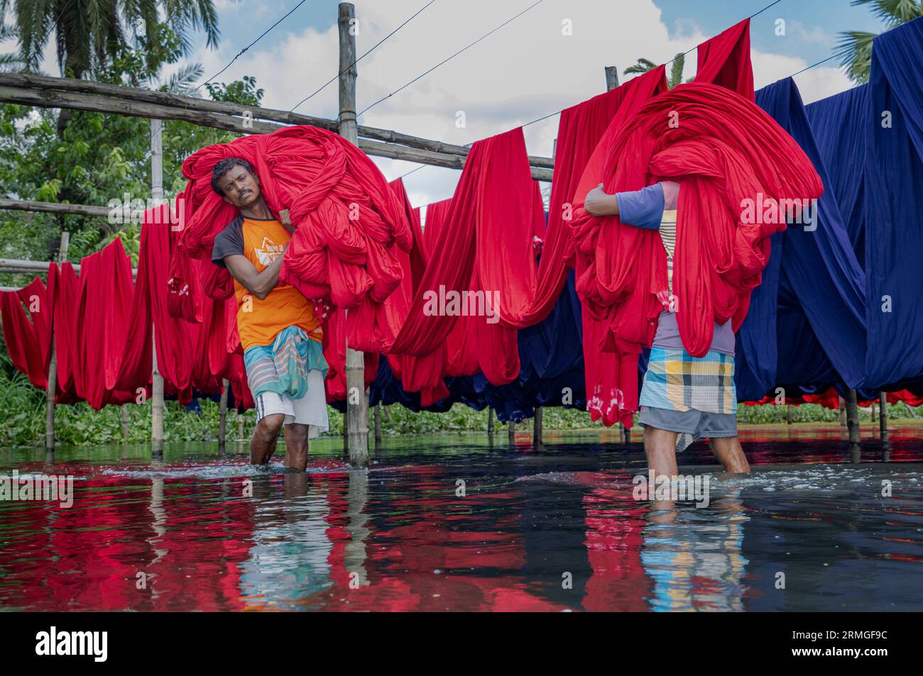 Dyed clothes of different colors are dried in the sun Stock Photo - Alamy