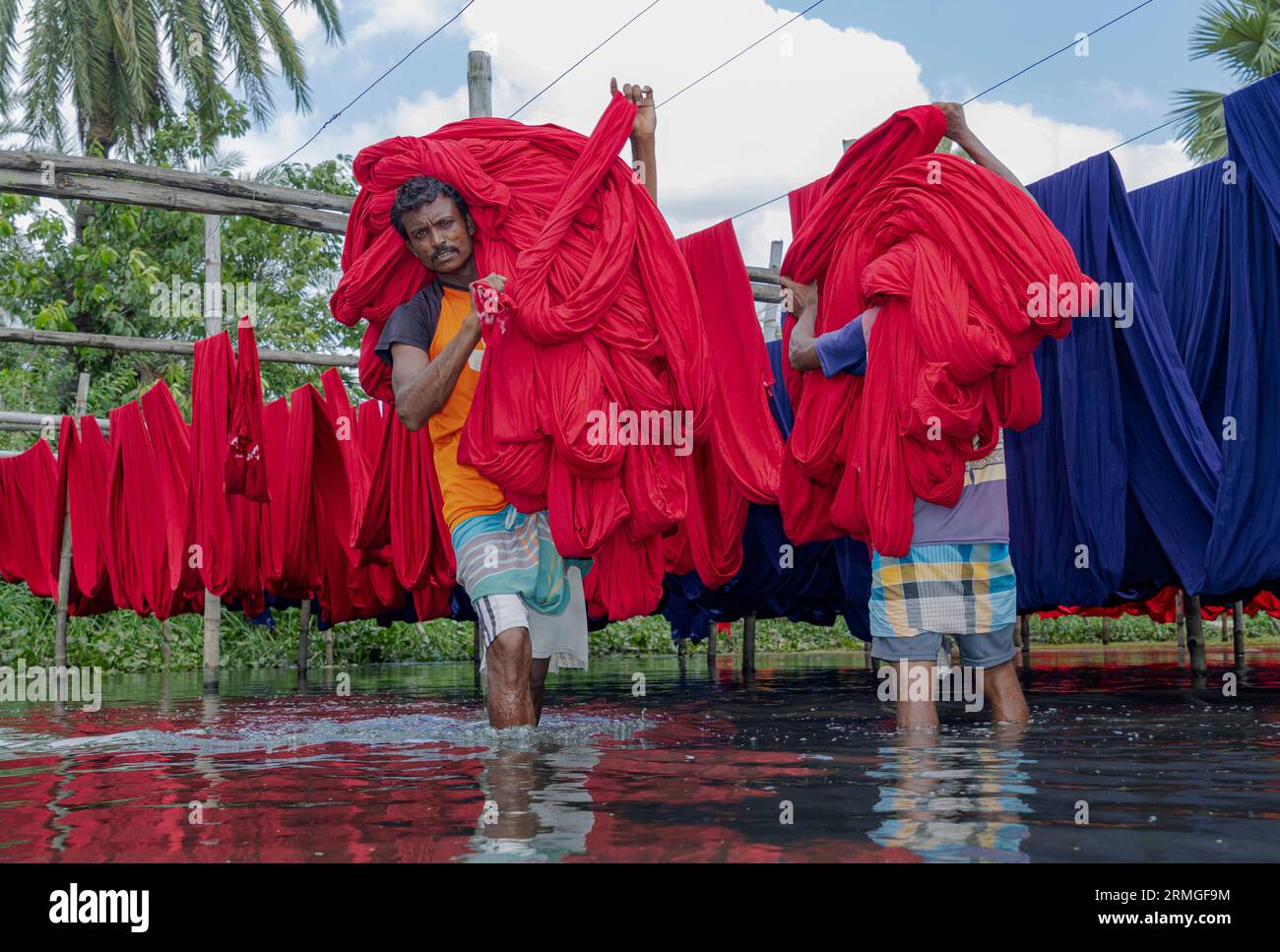 Dyed clothes of different colors are dried in the sun Stock Photo - Alamy