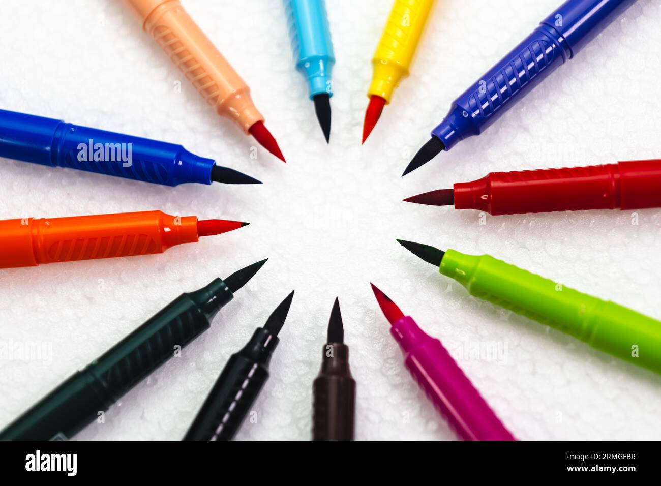 This close-up photo shows a colorful pen tip isolated on a white ...