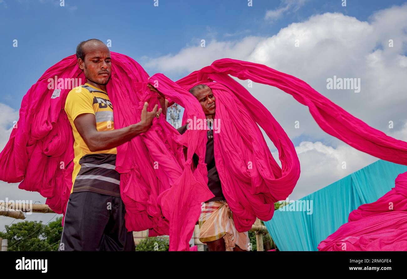 Dyed clothes of different colors are dried in the sun Stock Photo - Alamy