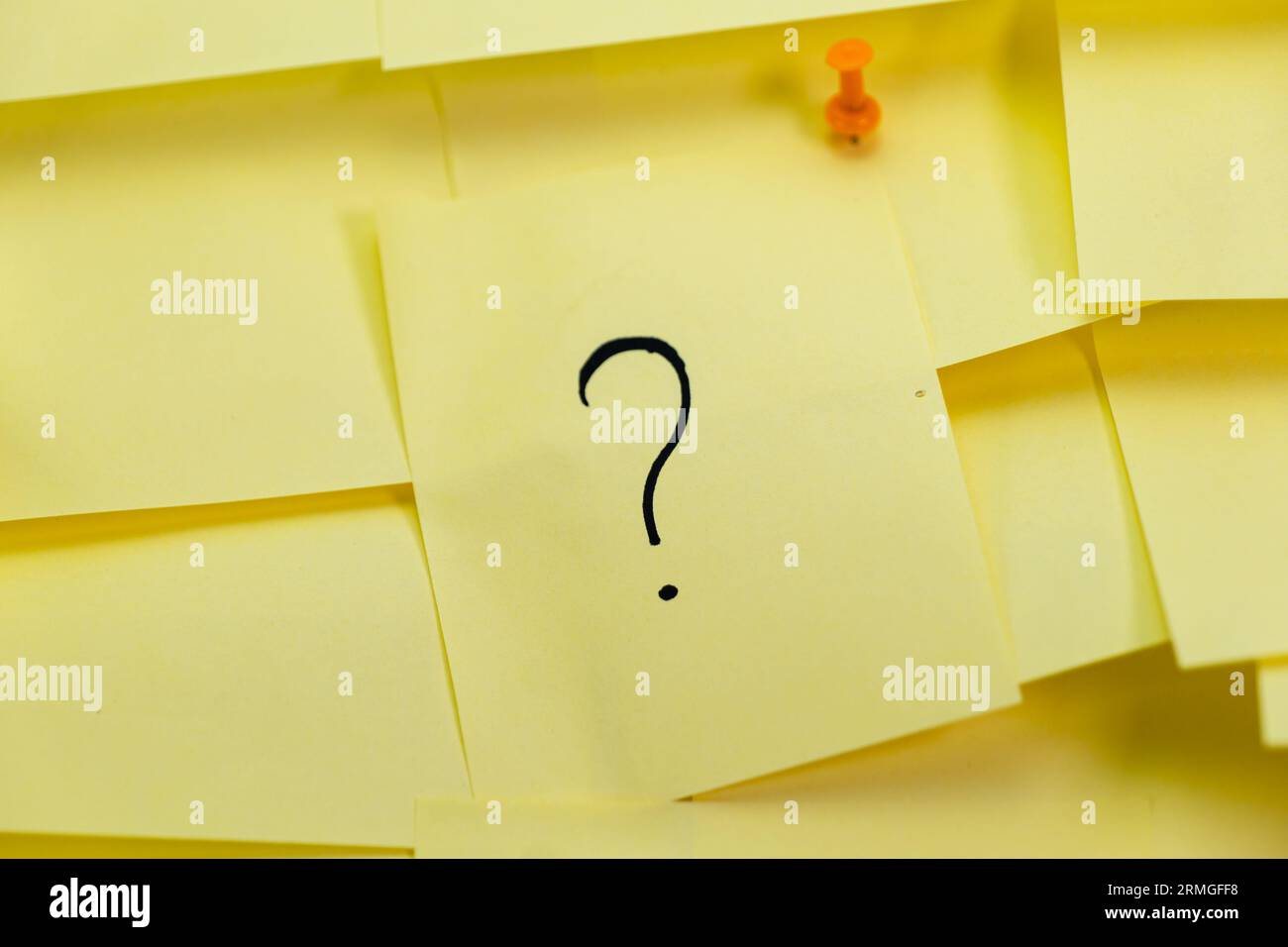 A stack of yellow sticky notes with question marks on them Stock Photo ...