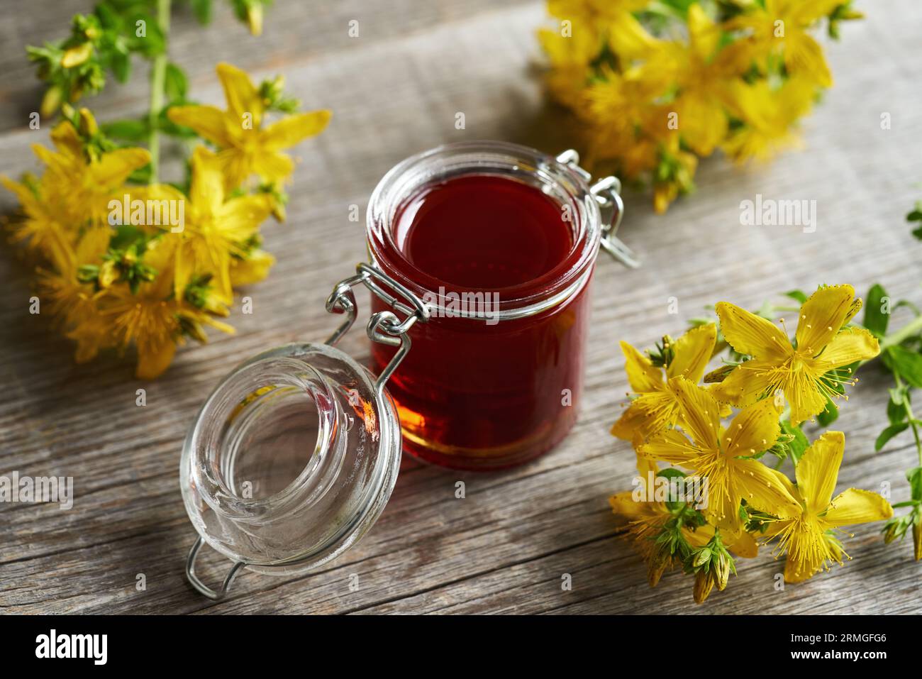 A jar of St. John's wort oil with Hypericum flowers Stock Photo - Alamy