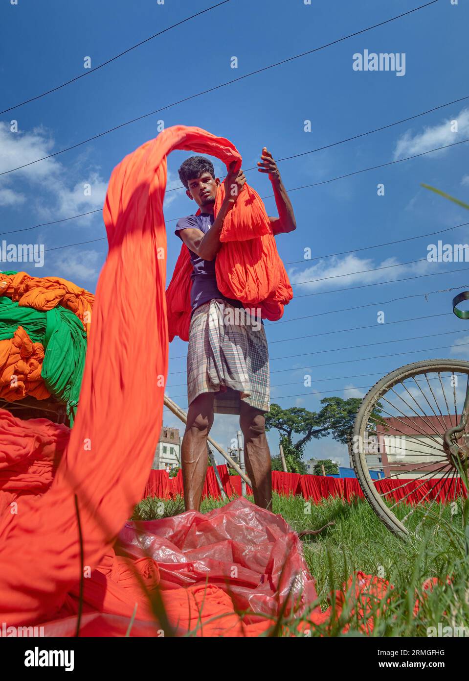 Dyed clothes of different colors are dried in the sun Stock Photo - Alamy