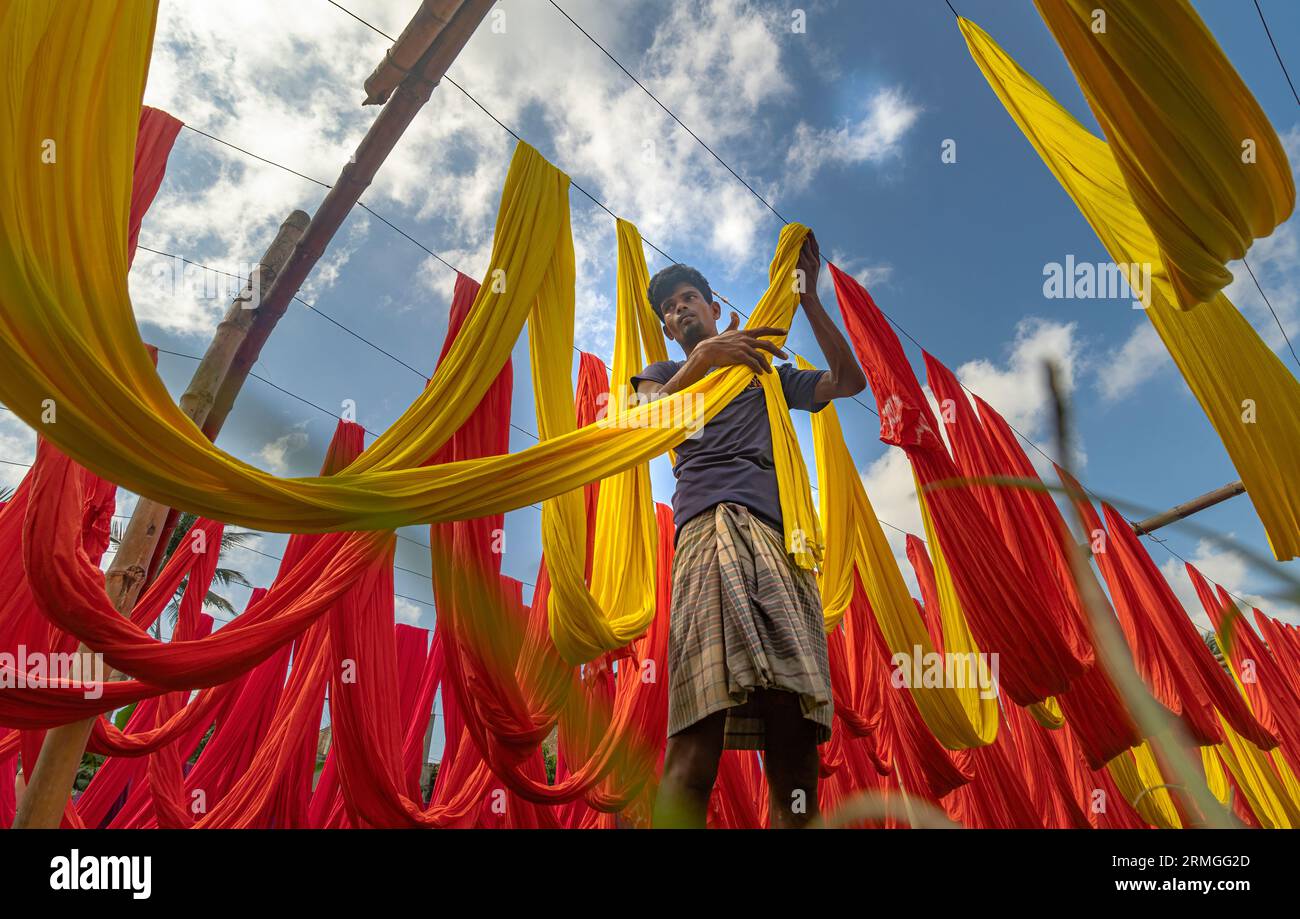 Dyed clothes of different colors are dried in the sun Stock Photo - Alamy