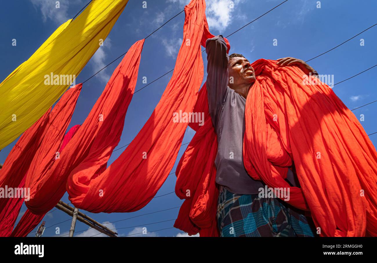 Dyed clothes of different colors are dried in the sun Stock Photo - Alamy