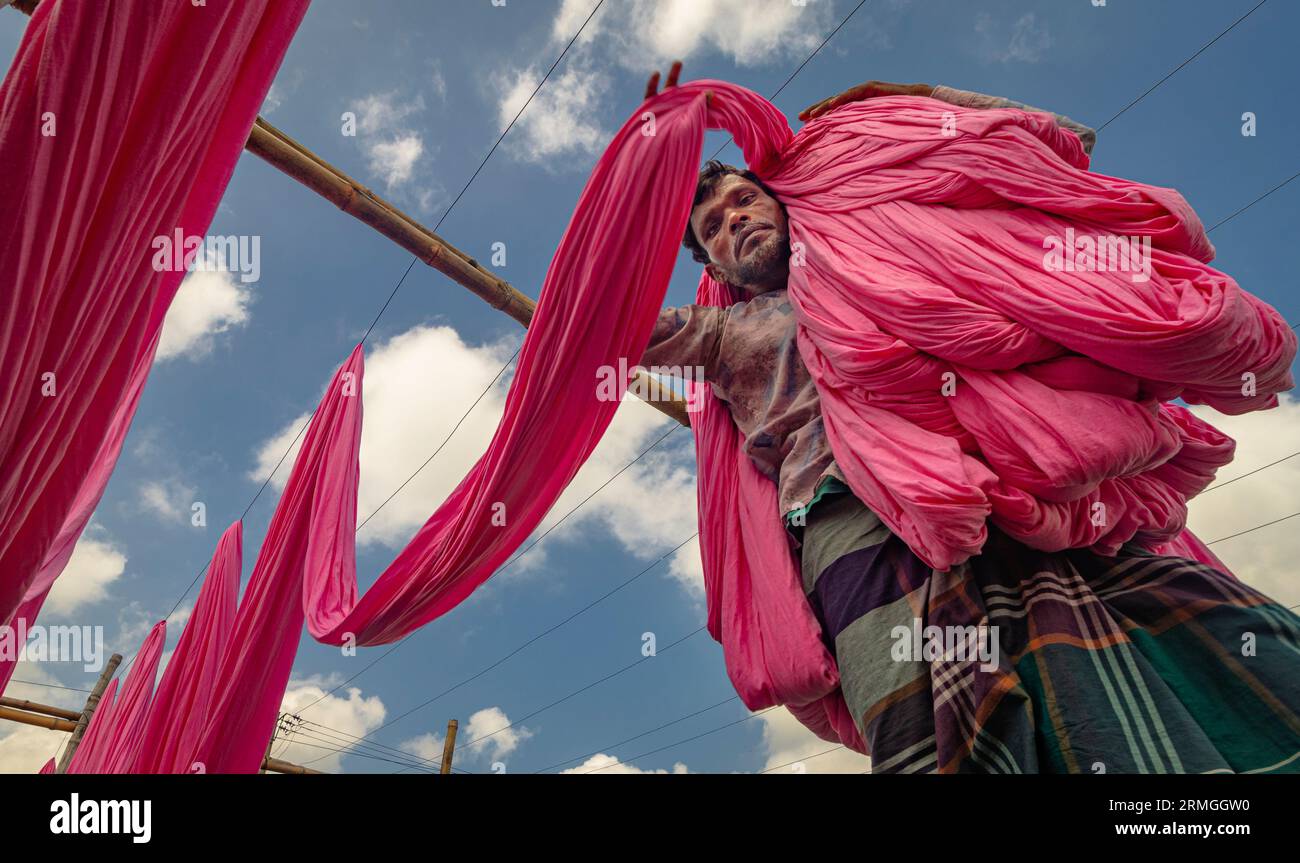 Dyed clothes of different colors are dried in the sun Stock Photo - Alamy
