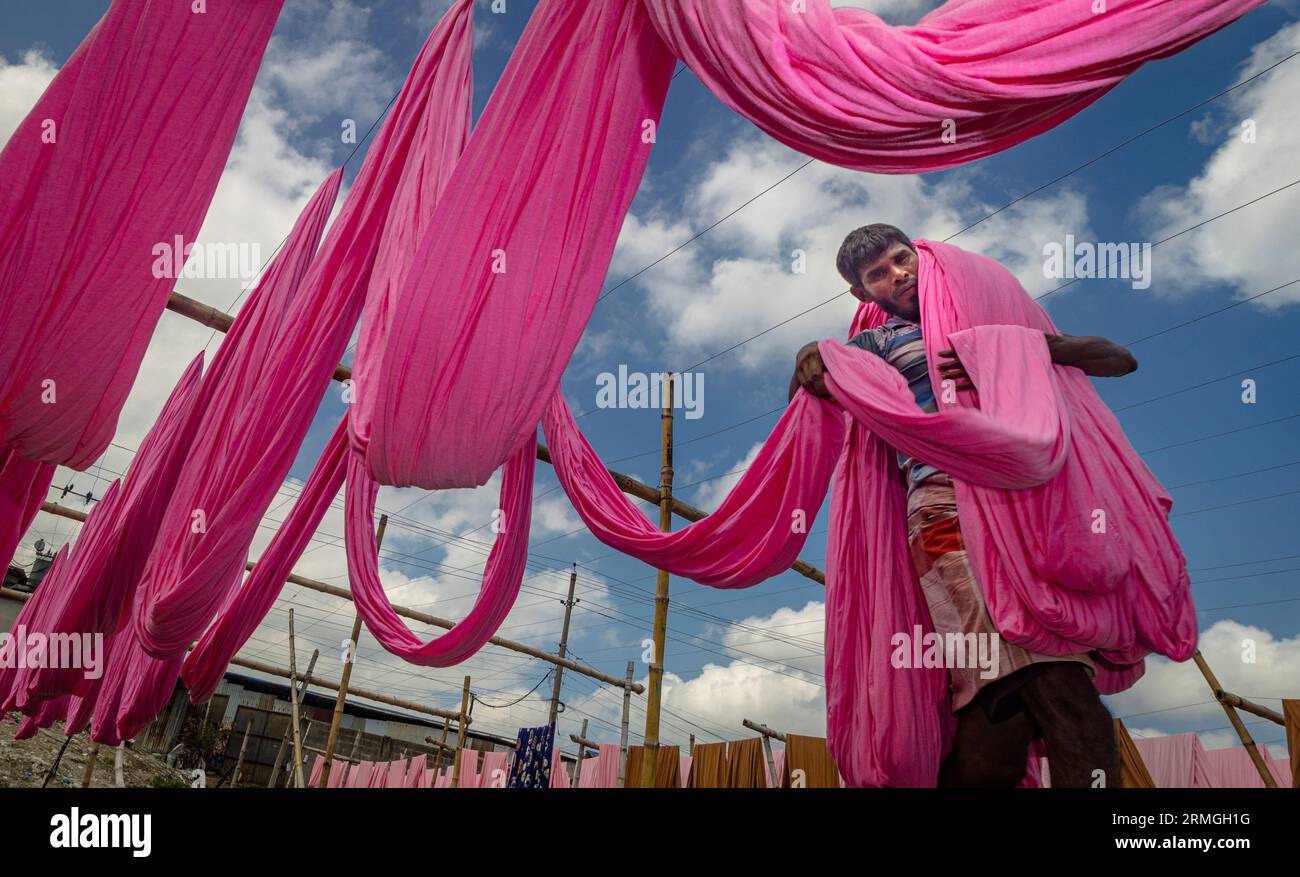 Dyed clothes of different colors are dried in the sun Stock Photo - Alamy