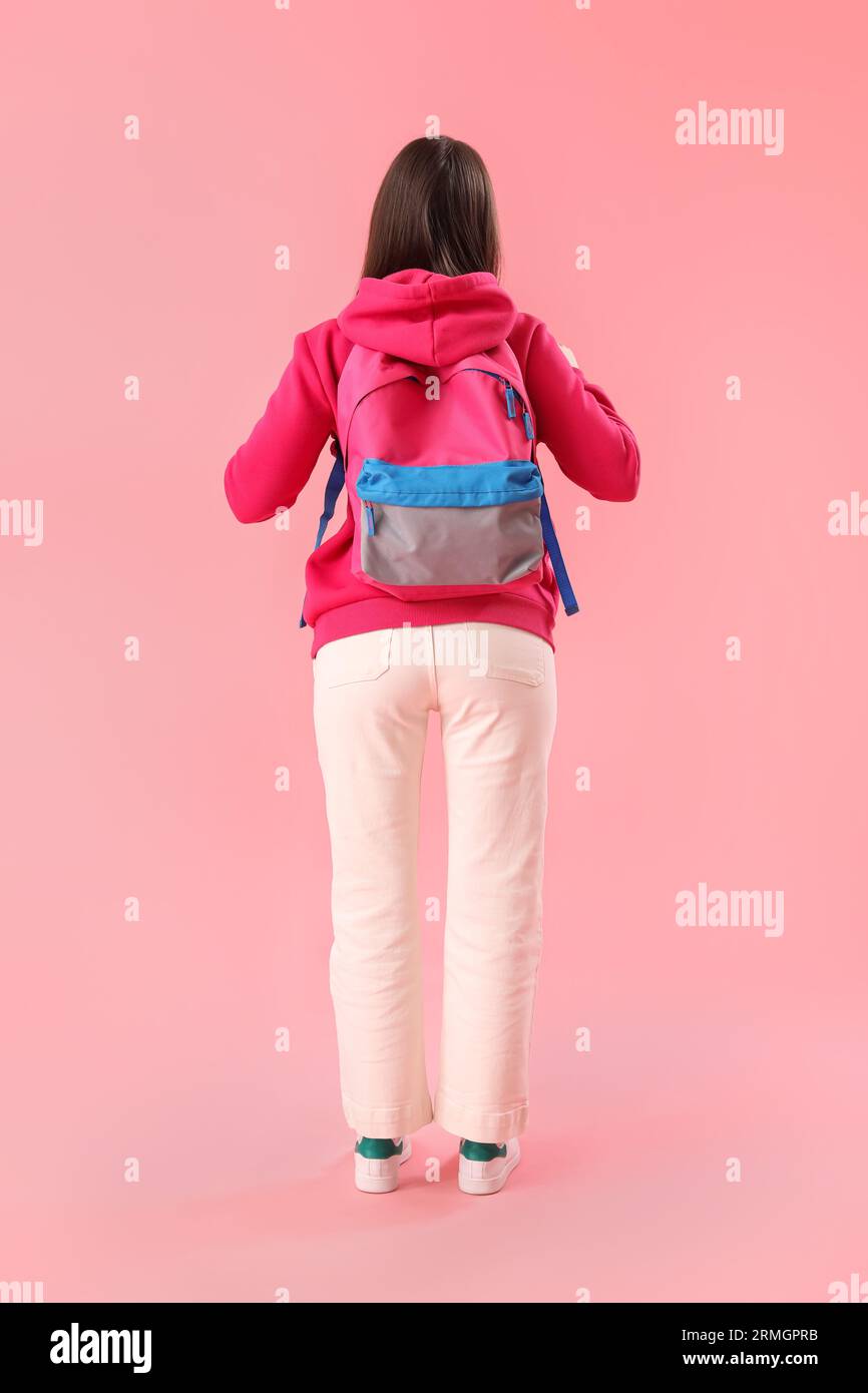 Female student with backpack on pink background, back view Stock Photo ...