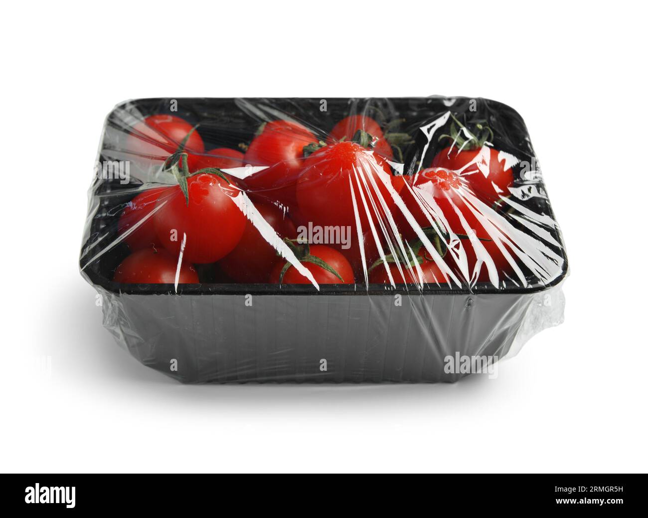 Plastic container of fresh tomatoes wrapped with stretch wrap on white ...