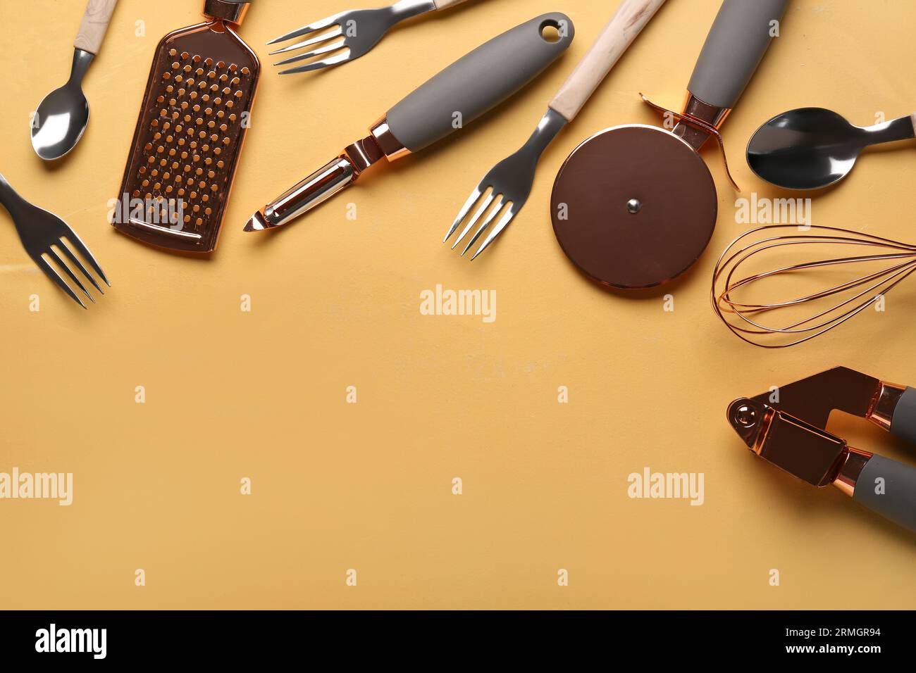 Different kitchen utensils on yellow background Stock Photo - Alamy