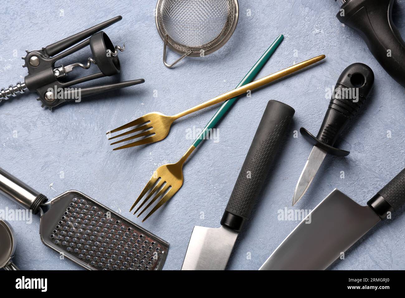 Different kitchen utensils on blue background Stock Photo - Alamy