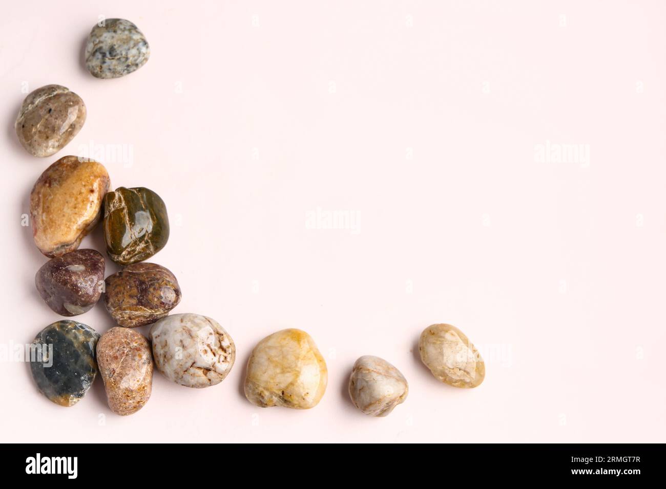 Many pebble stones on white background Stock Photo - Alamy