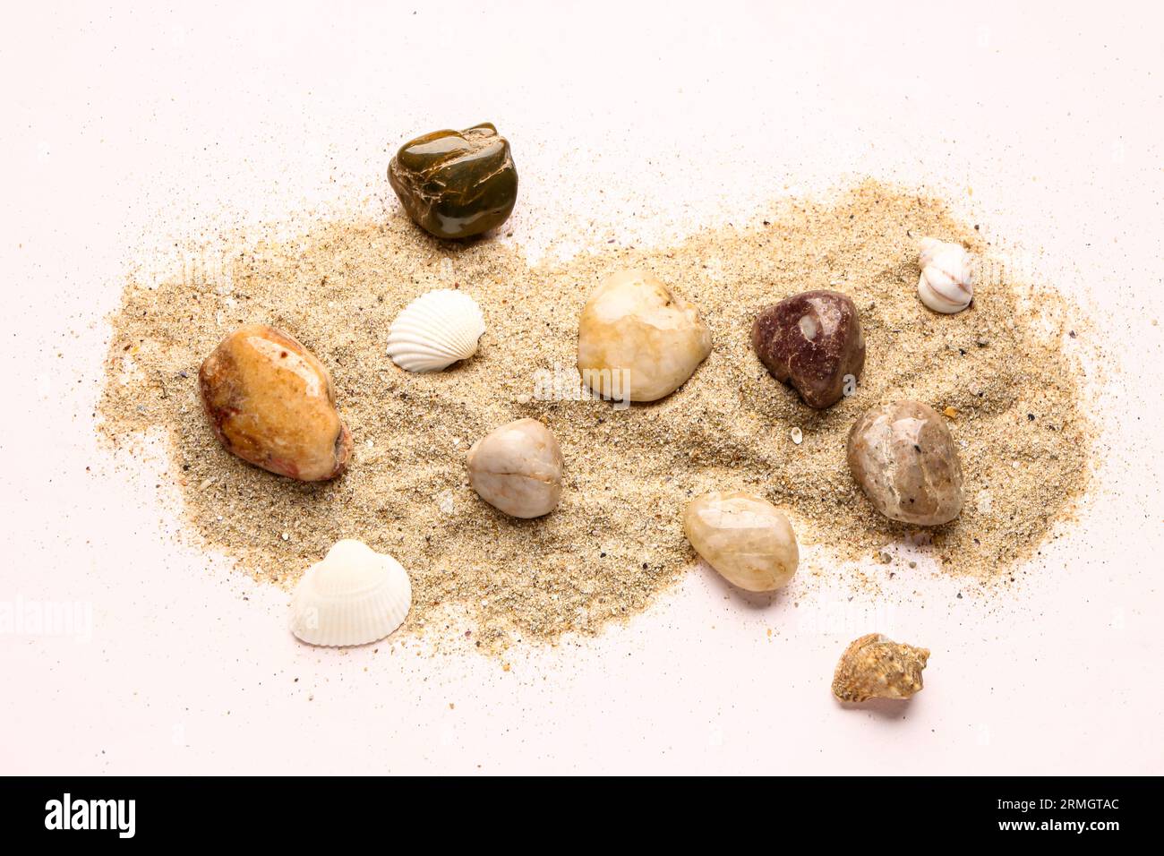 Pebble stones, seashells and sand on white background Stock Photo - Alamy