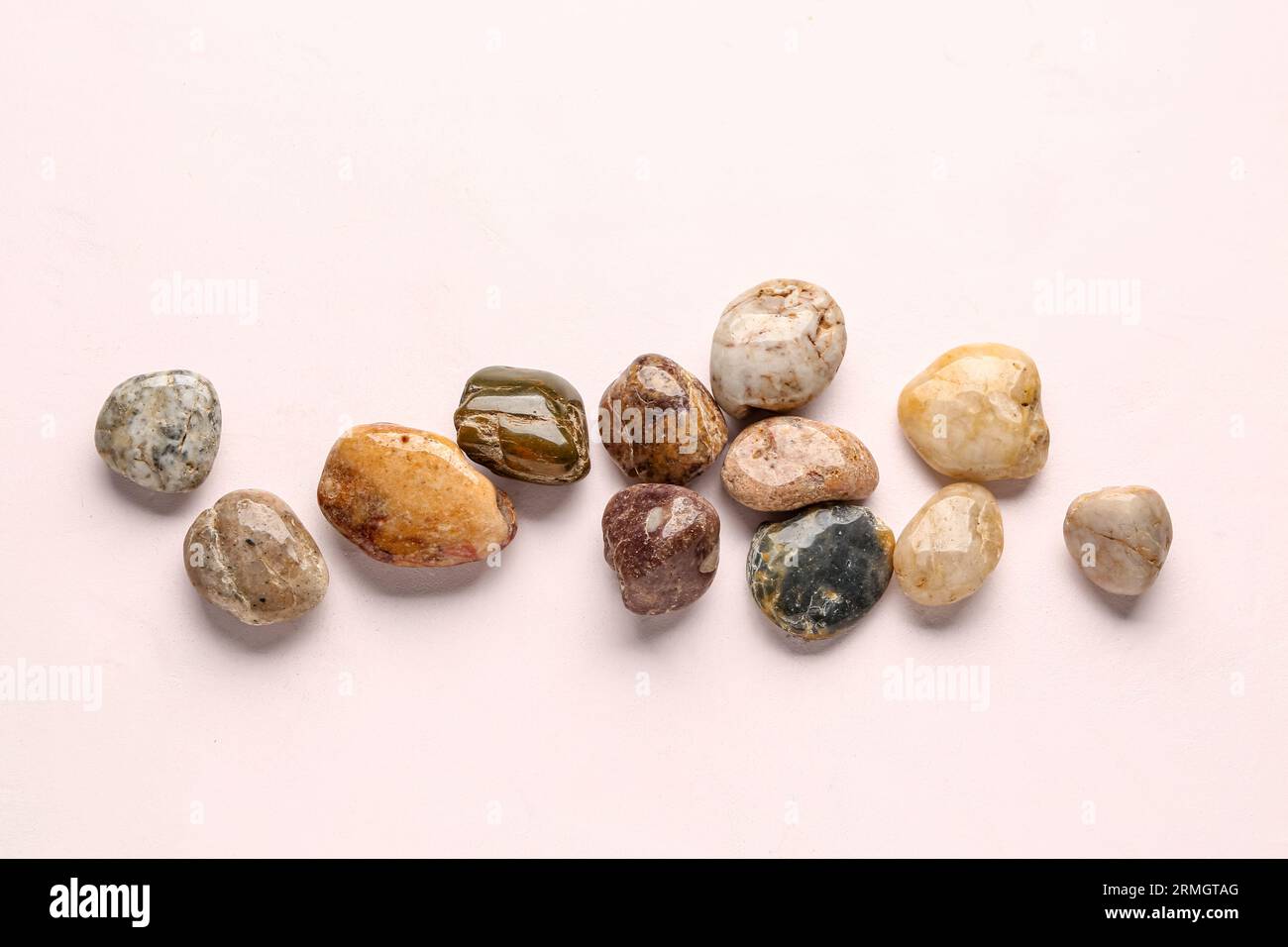 Many pebble stones on white background Stock Photo - Alamy