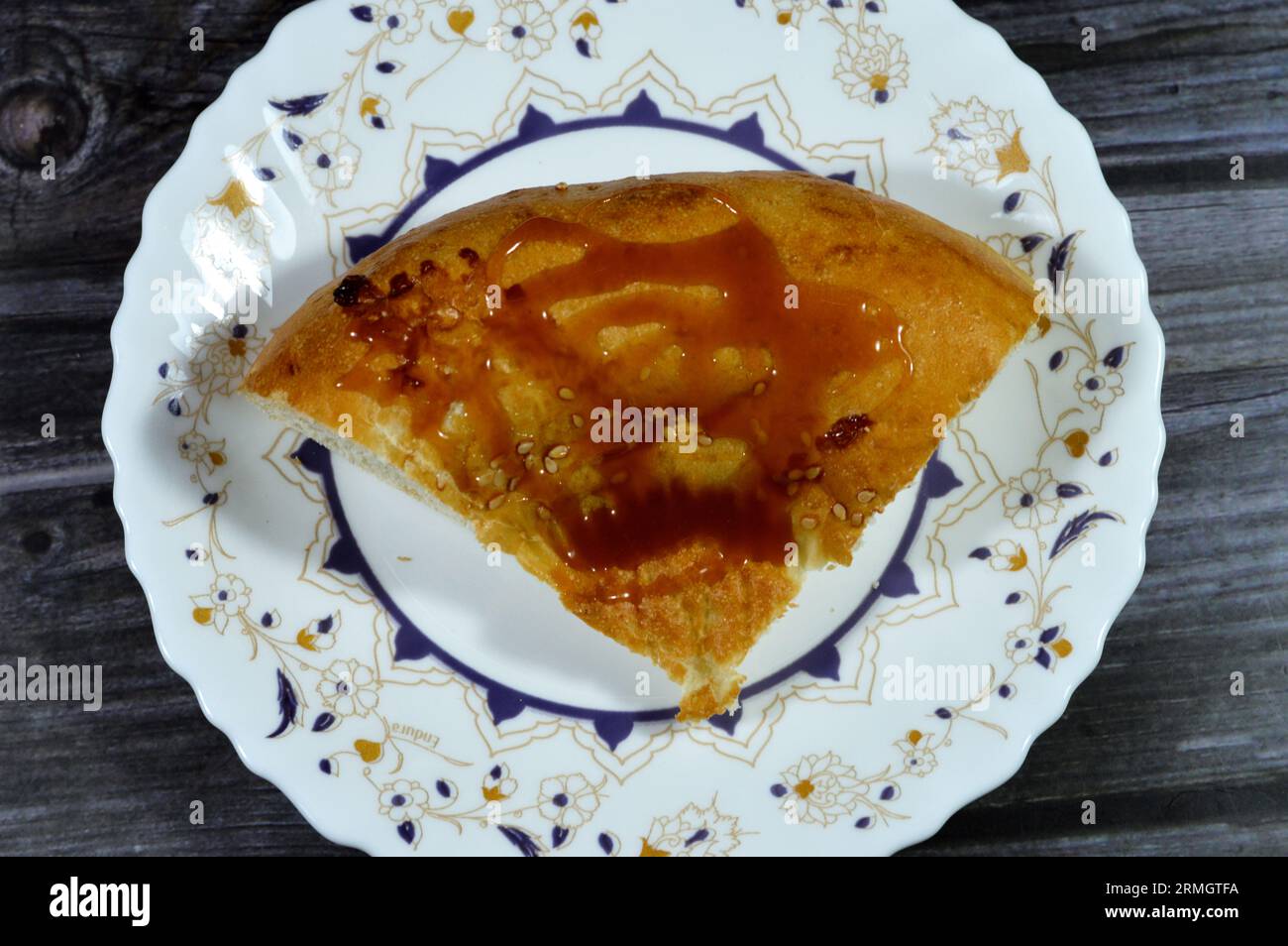 Caramel sauce topping on a tandyr nan Uzbek bread, a type of Central ...