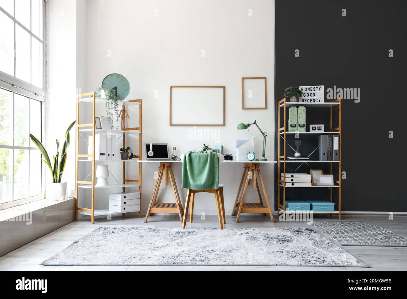 Interior of light office with workplace and shelving units Stock Photo ...