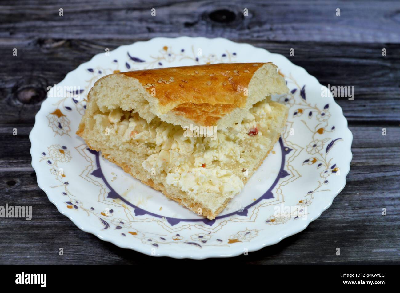 White cheese inside a piece of a tandyr nan Uzbek bread, a type of ...