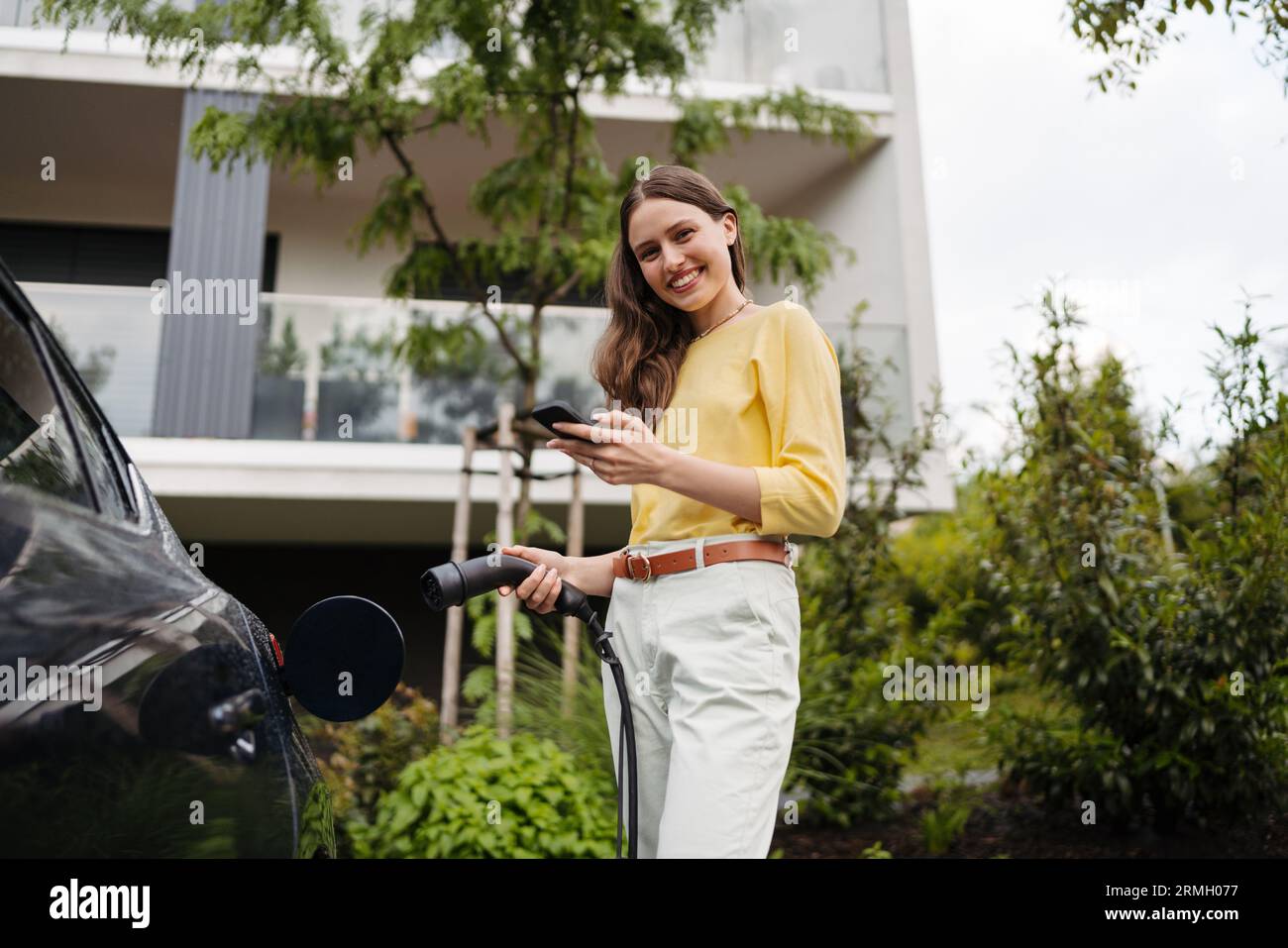 Woman plugging smartphone power hi-res stock photography and images - Alamy