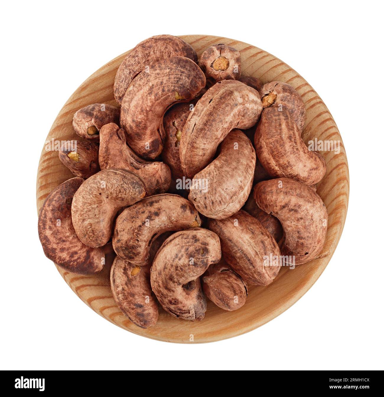 cashew nuts heap with shell in wooden bowl isolated on white background ...