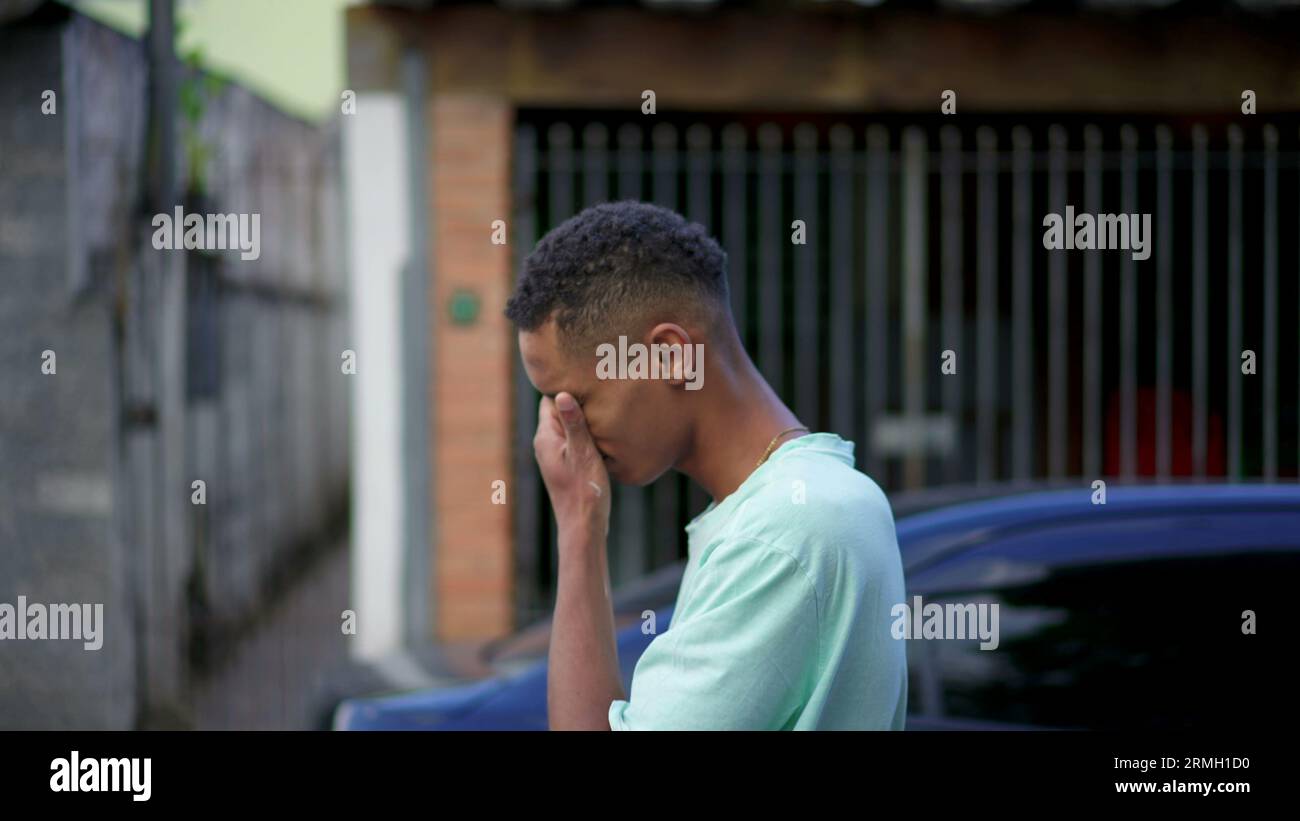 One pensive young black Brazilian man concerned about life while ...