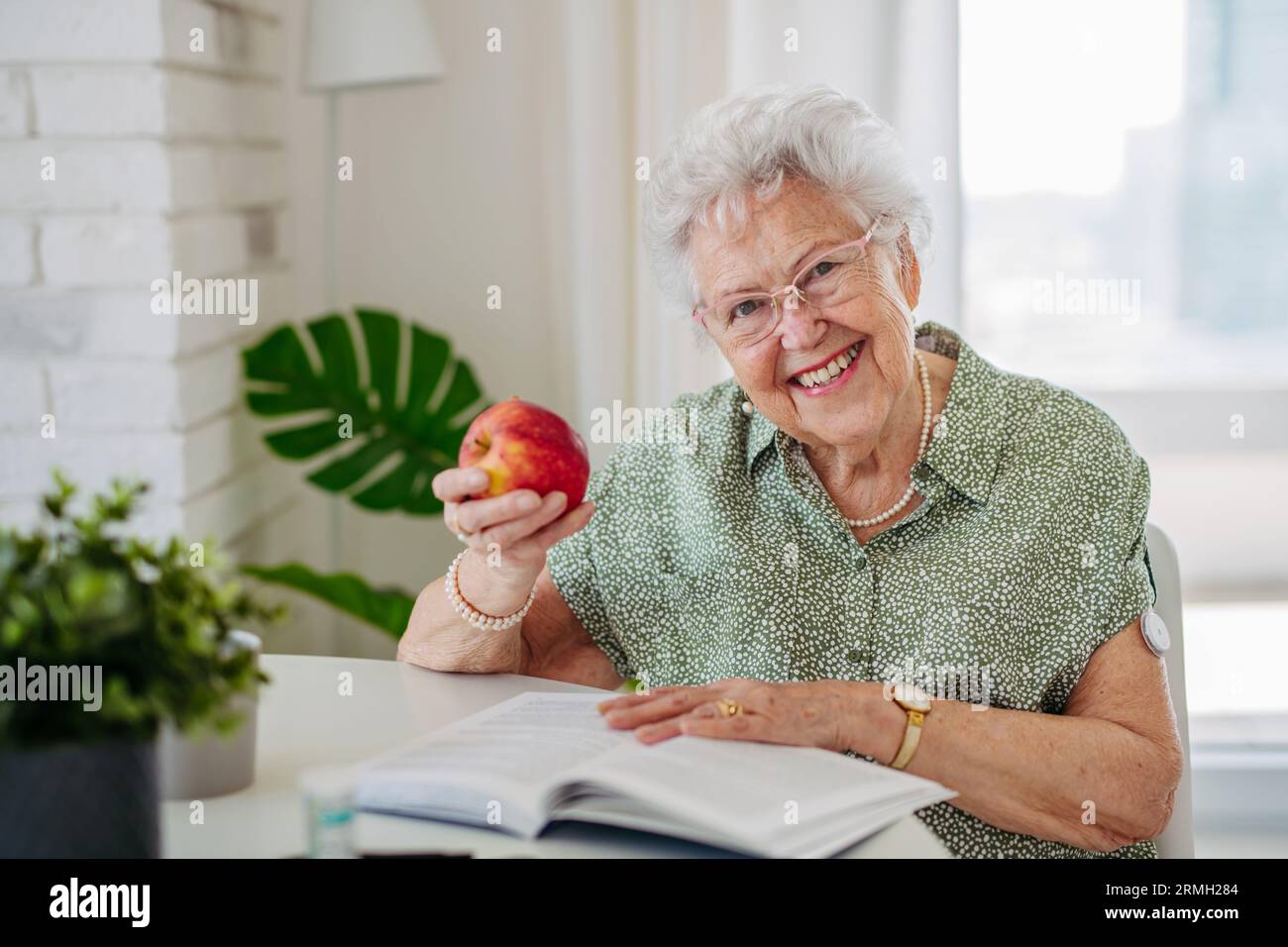 Diabetic senior patient using continuous glucose monitor to check blood ...