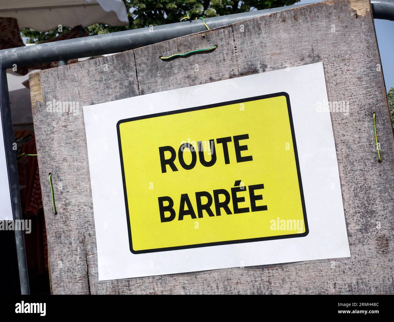 Sign with text in French: Route barree. This means in English that the ...