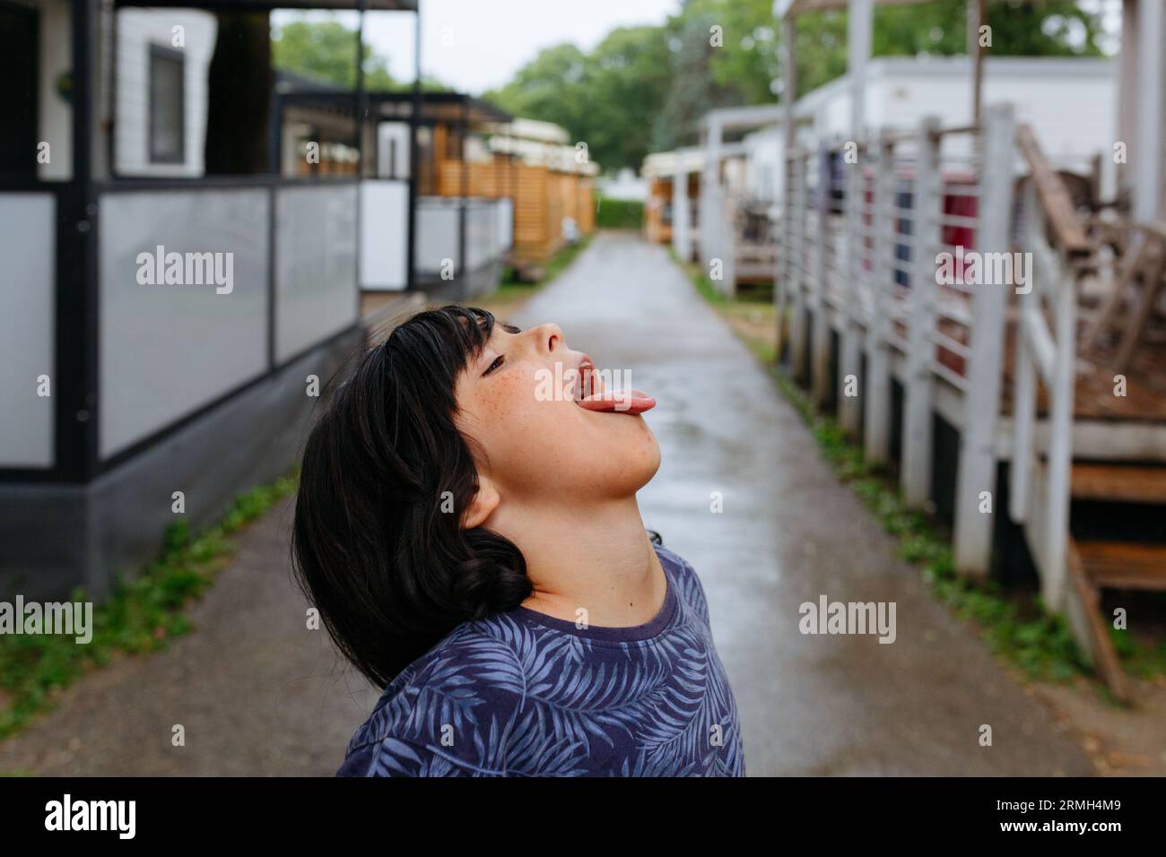 a portrait of the child tasting the rain with the tongue Stock Photo ...