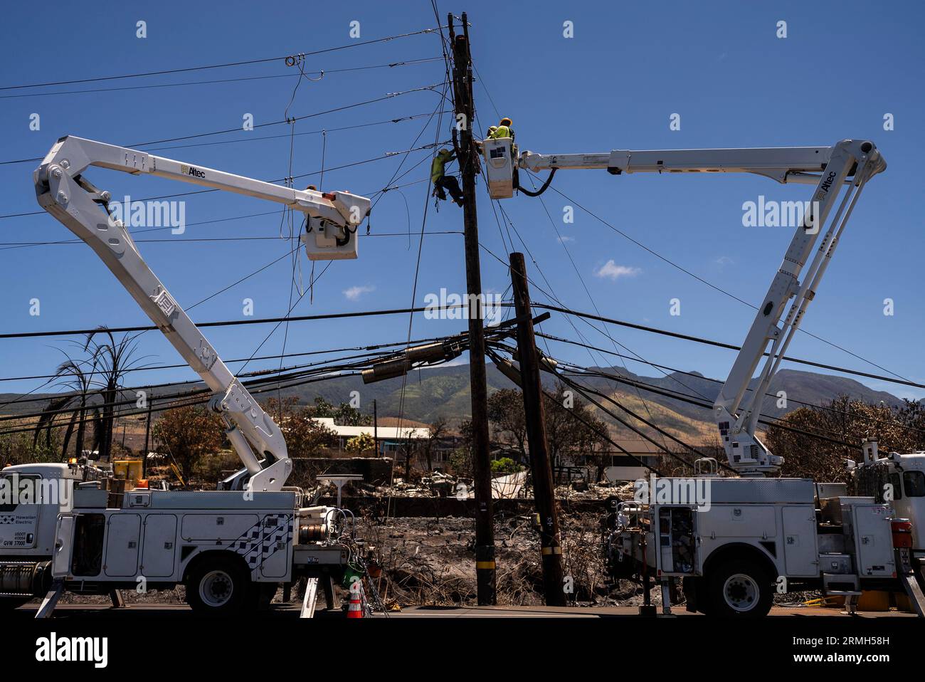 Electric crews work on power lines in the aftermath of a devastating ...