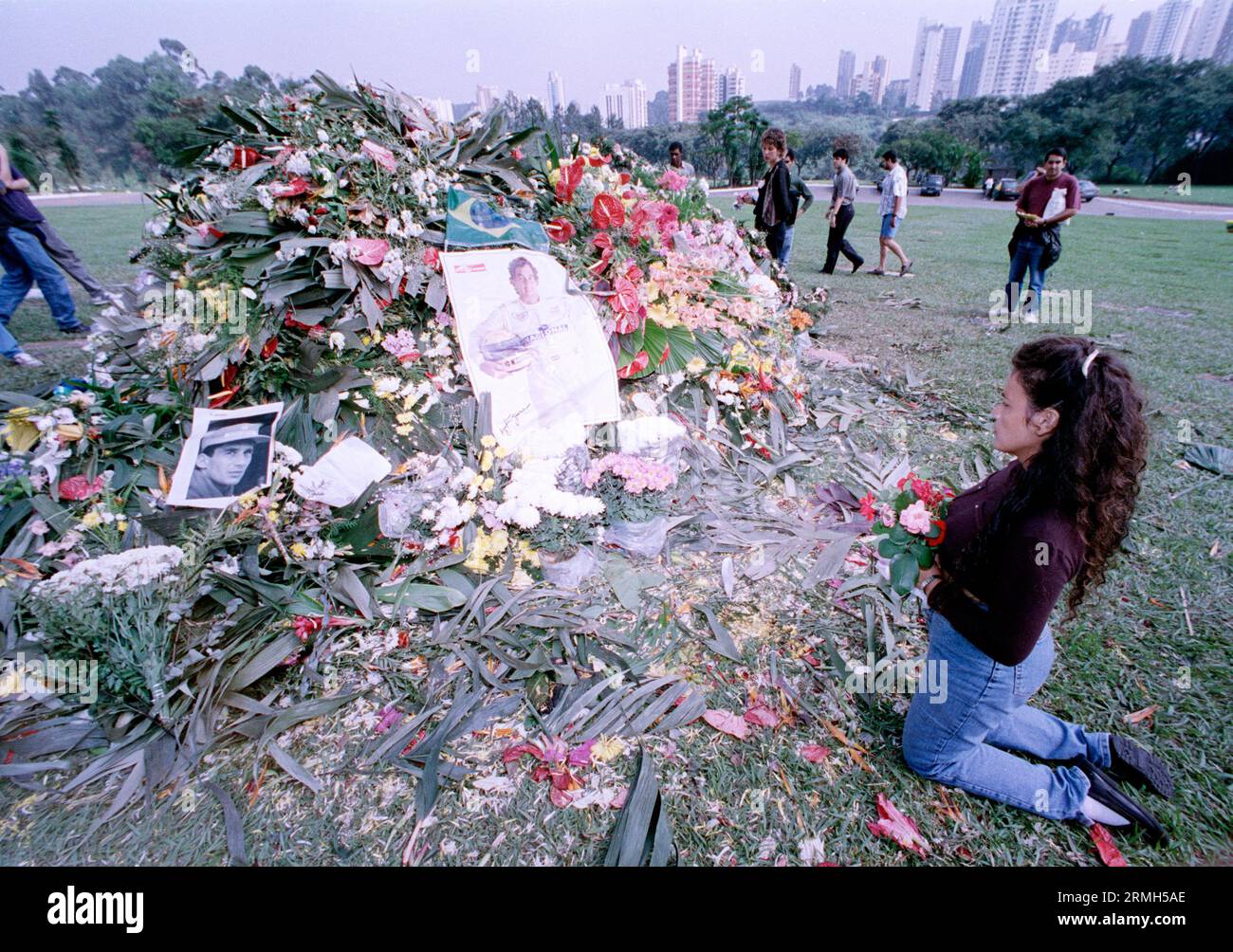 A woman kneels in prayer at the grave of Formula One champion Ayrton ...