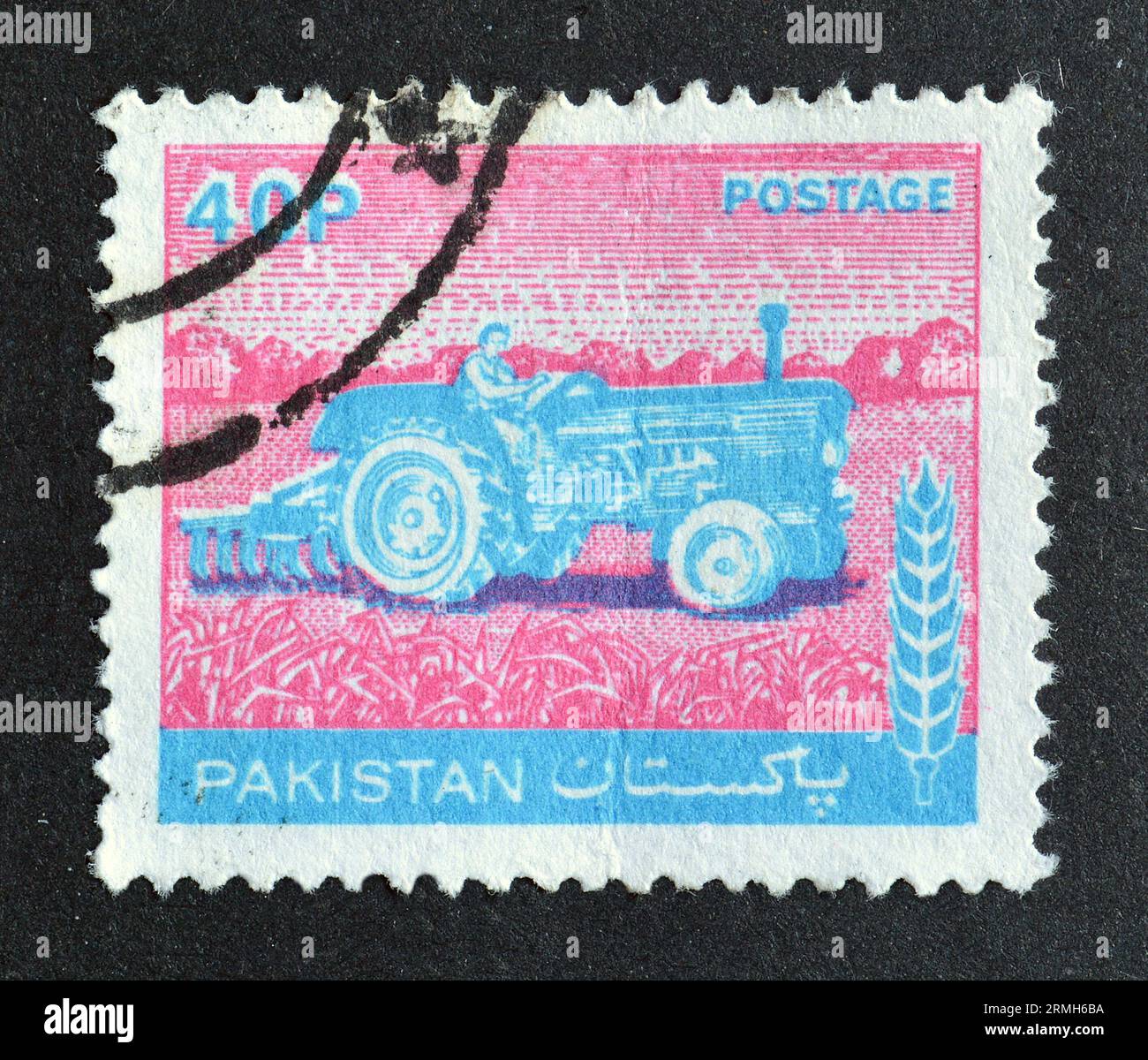 Cancelled postage stamp printed by Pakistan, that shows Woman Tractor ...