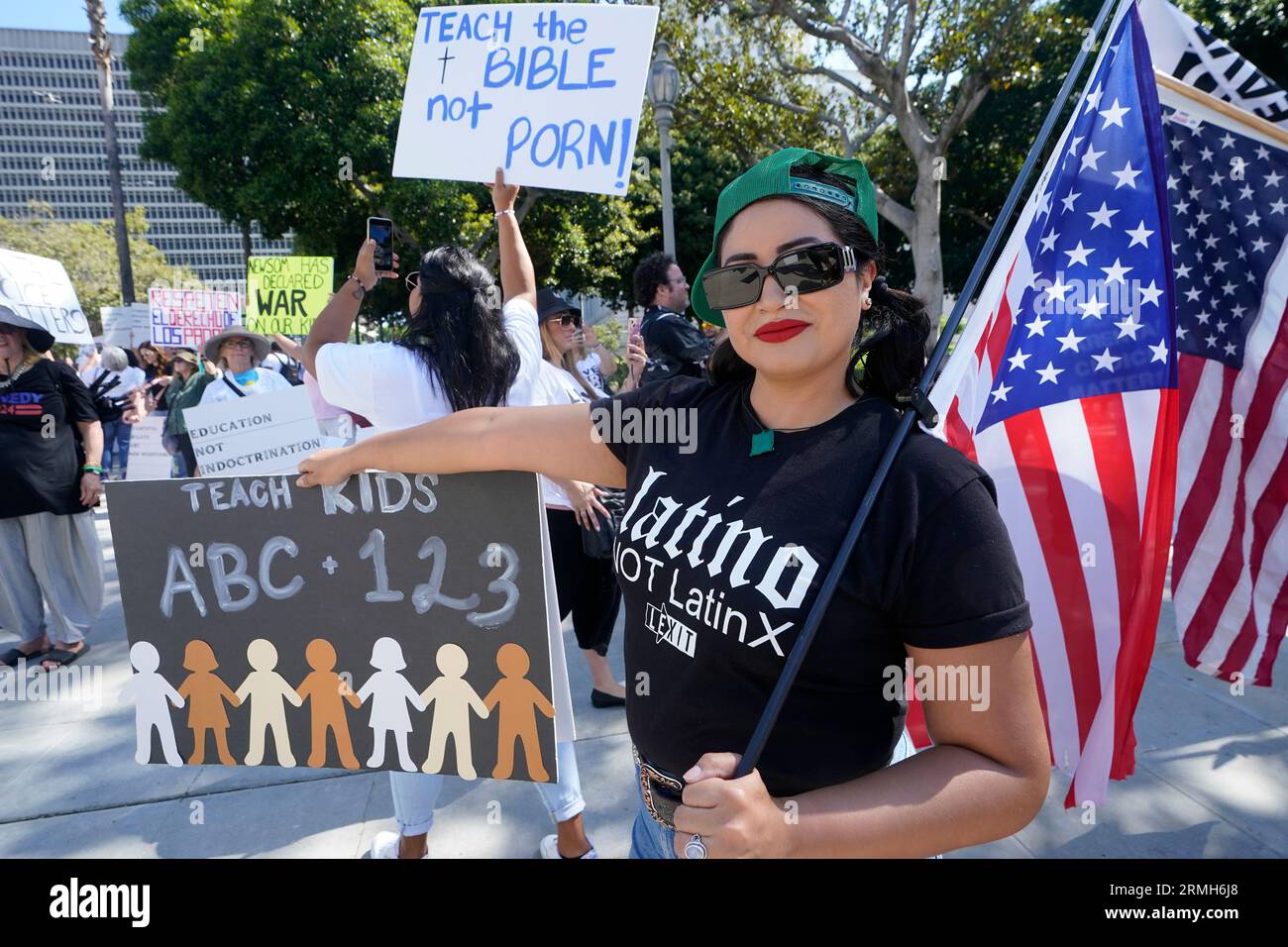 A demonstrator with Leave Our Kids Alone holds a sign at a rally ...