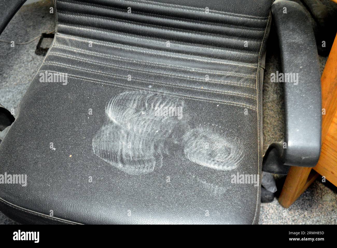 footwear impression shoe print left on a leather chair, dirty dusty ...