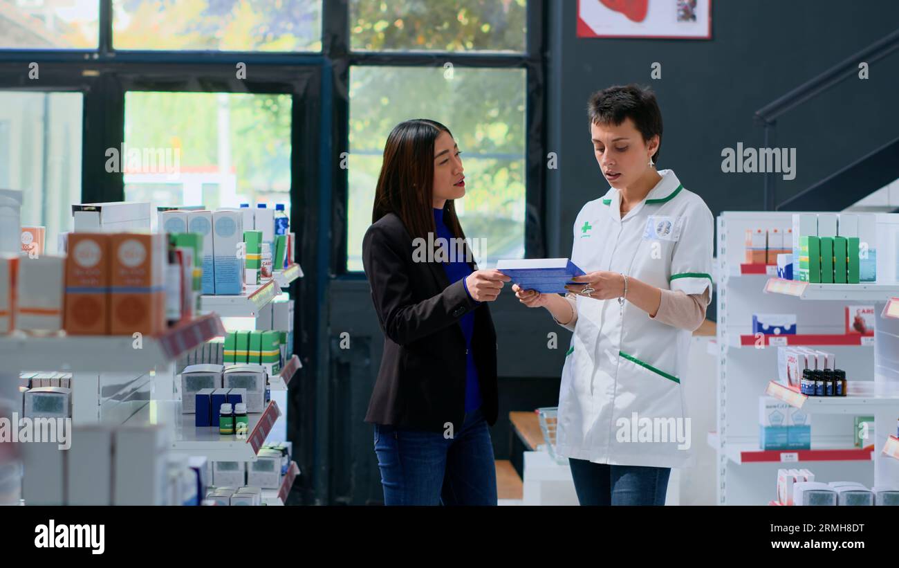 Chemist store employee taking break from arranging inventory on shelves ...