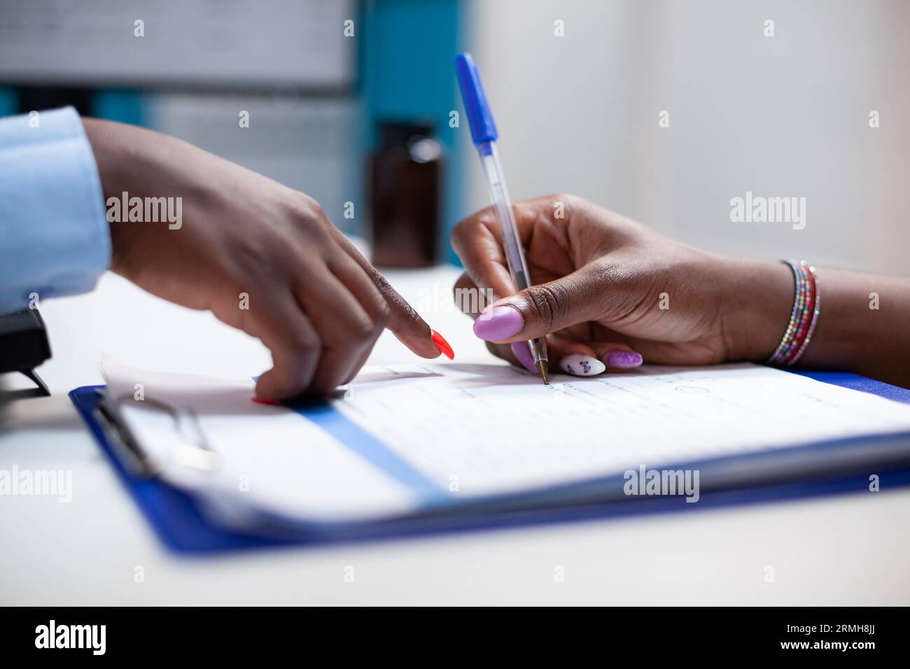 Doctor helping patient signing paperwork of medical insurance document ...