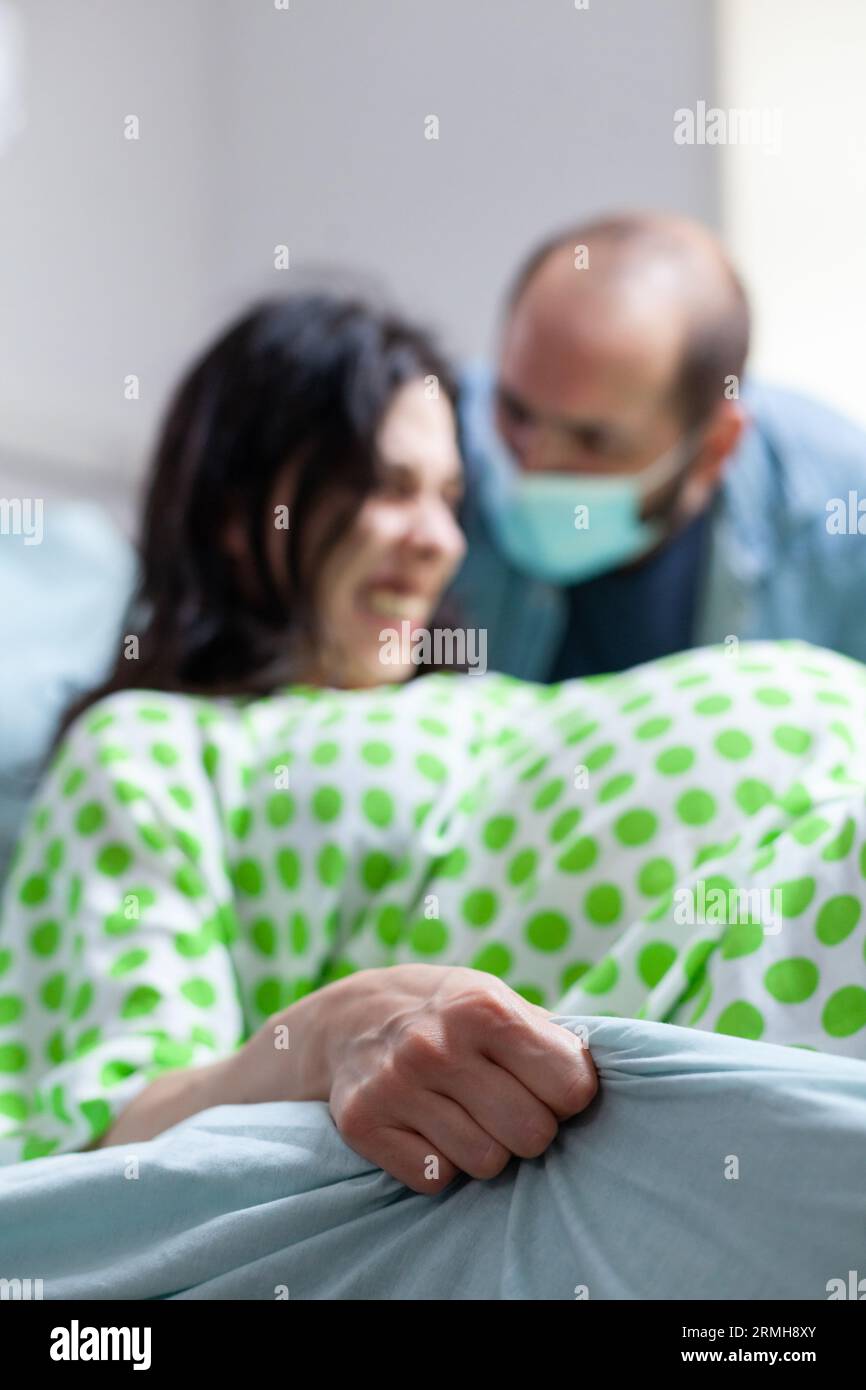 Pregnant woman trying to delivery baby in hospital ward, having husband ...