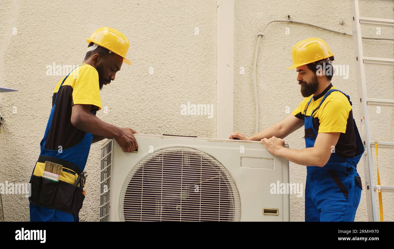 Teamworking knowleadgeable engineer starting work on defective hvac ...