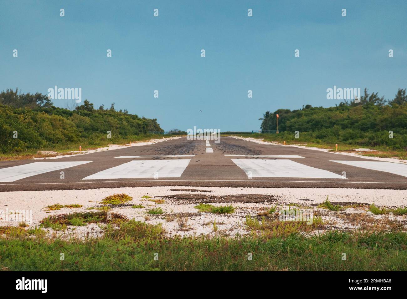 the end of the airport runway on the island of Caye Caulker, Belize ...