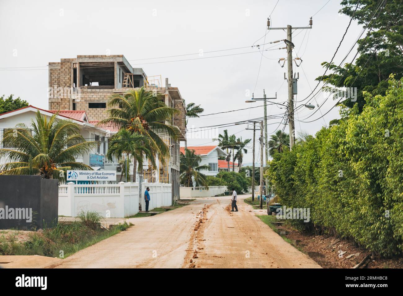 a dirt road with new home construction in Belize City, Belize Stock ...
