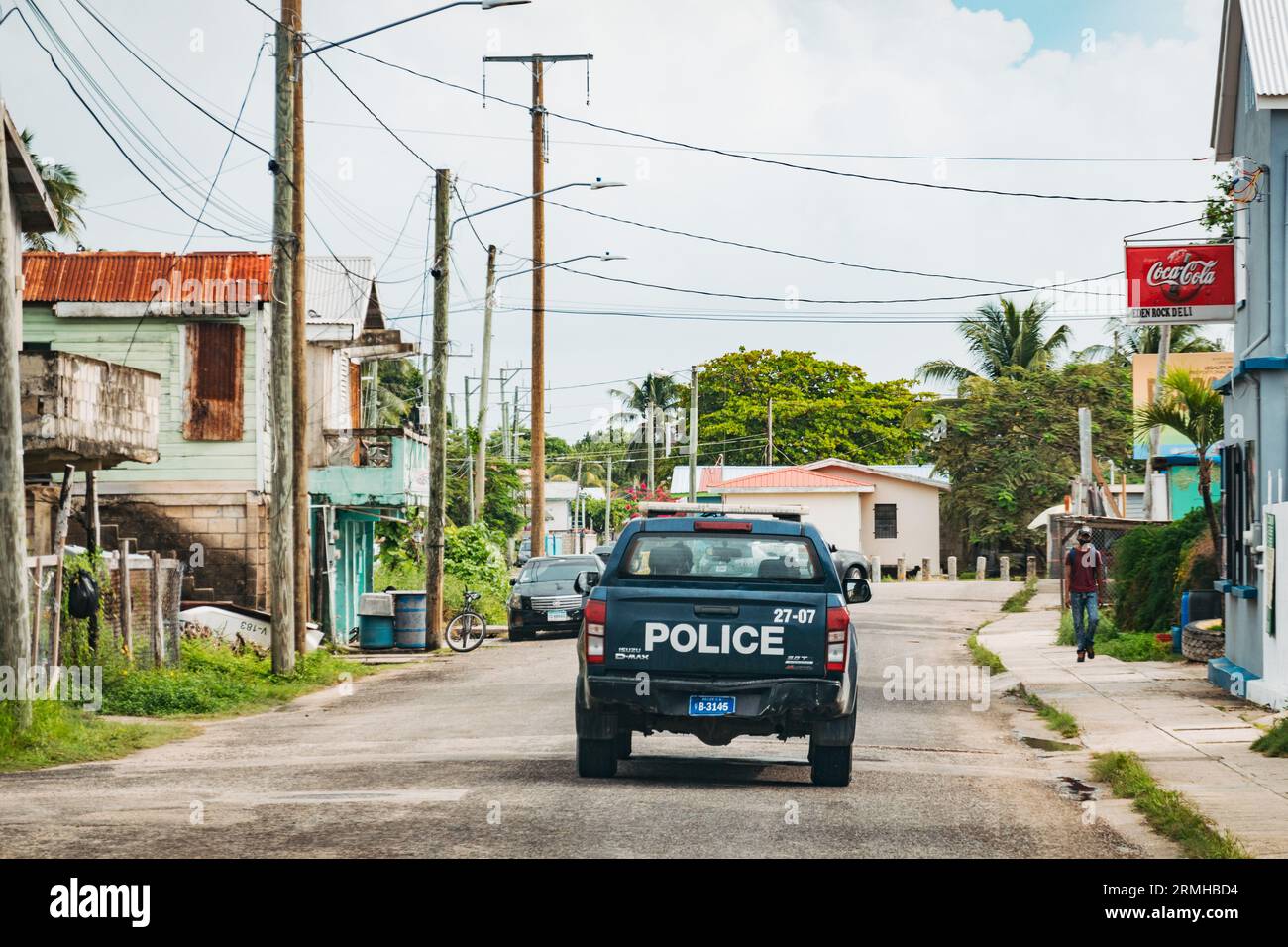 a police truck patrols a residential street in Belize City, Belize ...