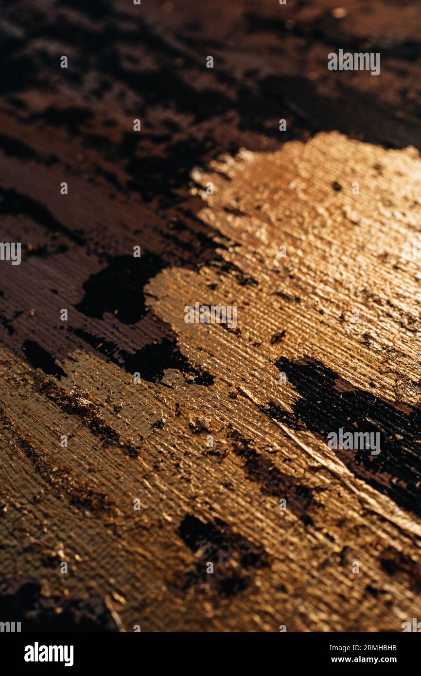 Abstract contemporary paint black oil strokes and glow golden shiny ...