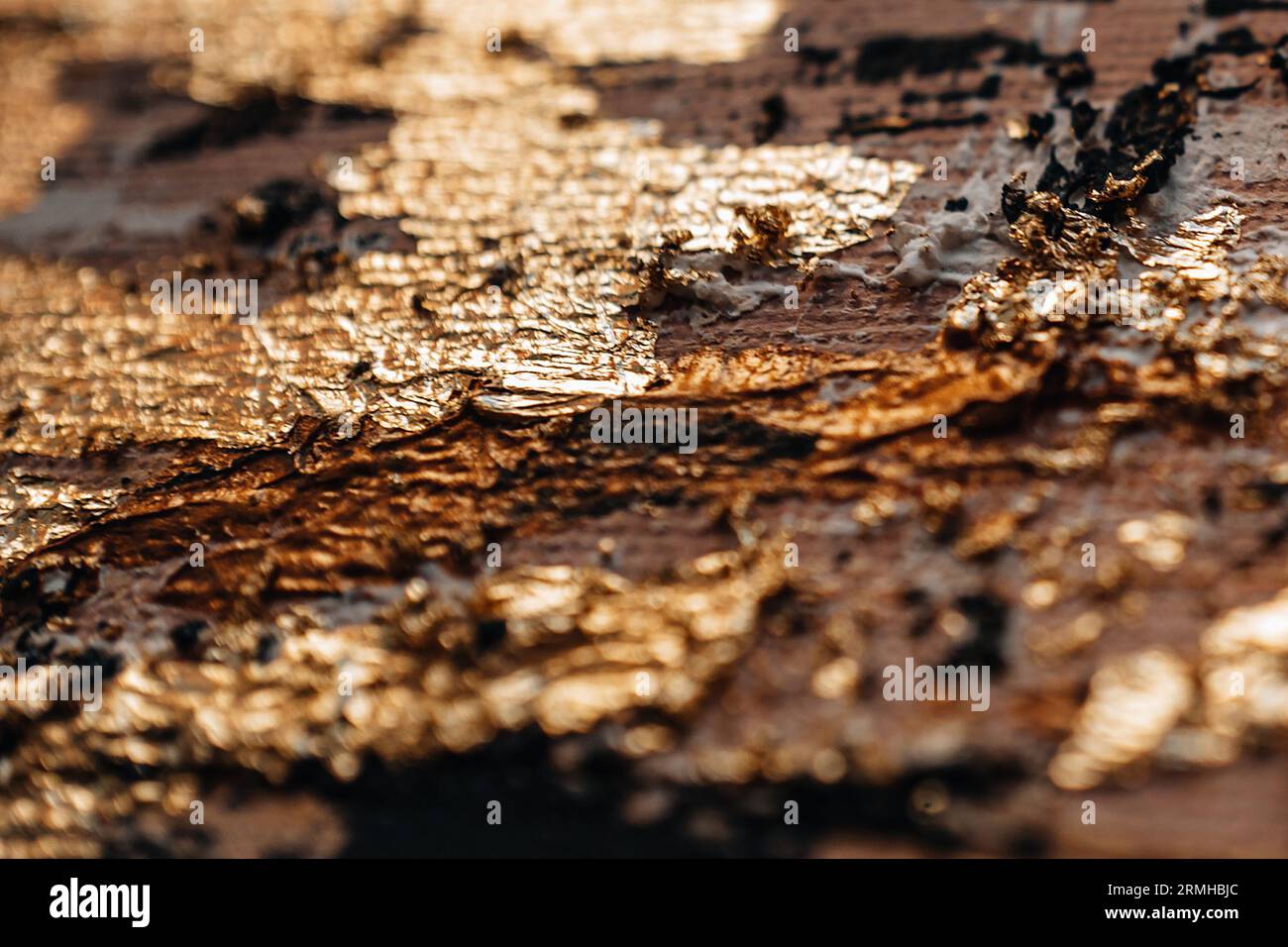 Abstract wall painting with black oil strokes and glow shine gold ...