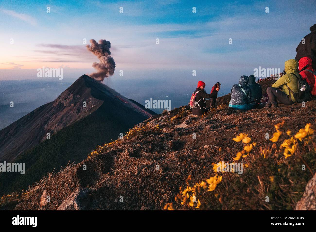 Tourists watch Agua Volcano, at sunrise from atop Acatenango Volcano ...