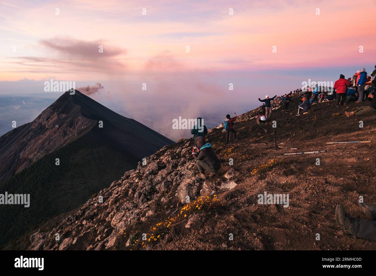 Tourists watch Agua Volcano, at sunrise from atop Acatenango Volcano ...